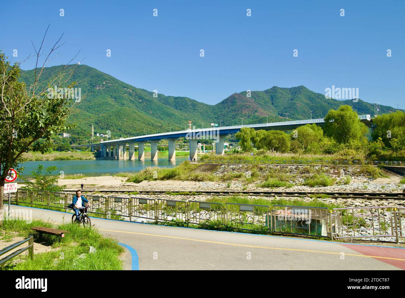 Hanam City, South Korea - October 1, 2023: A cyclist pedals along a ...