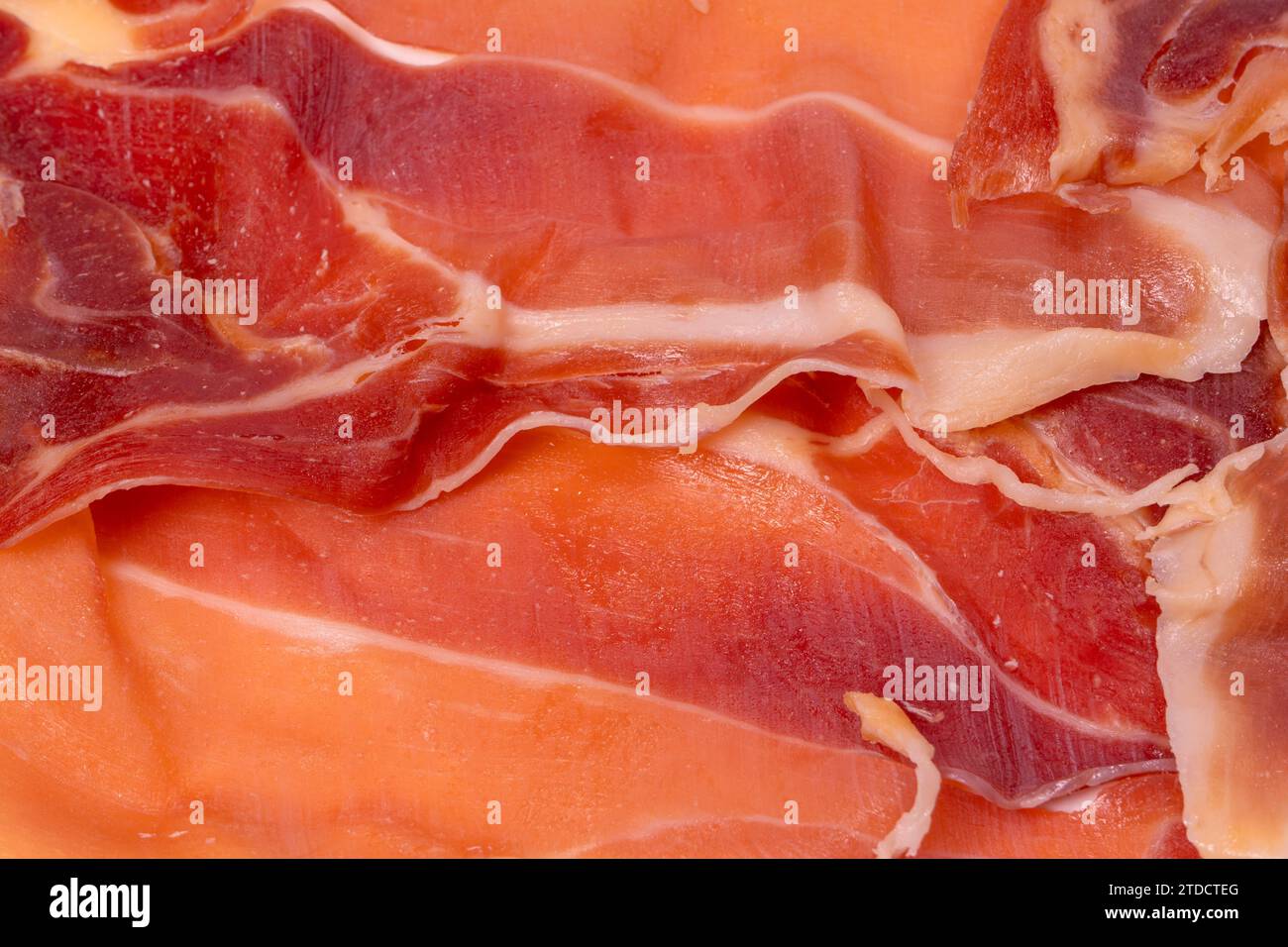 Thinly sliced jamon isolated on white background. Top view Stock Photo ...