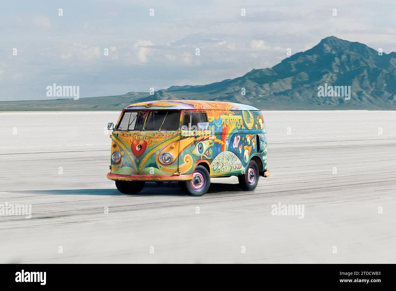 VW Psychedelic hippie van driving on the Bonneville Salt flats Utah USA ...