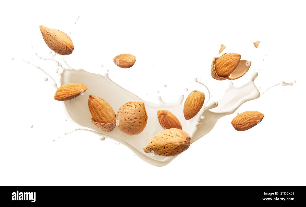 Almonds with milk splash isolated on white background Stock Photo - Alamy