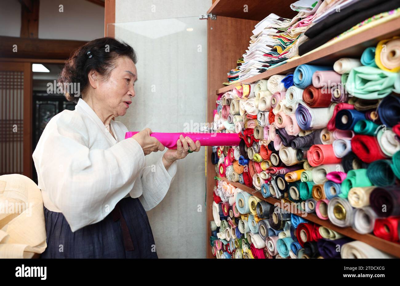 A master of traditional Korean clothing, Hanbok, is examining the ...