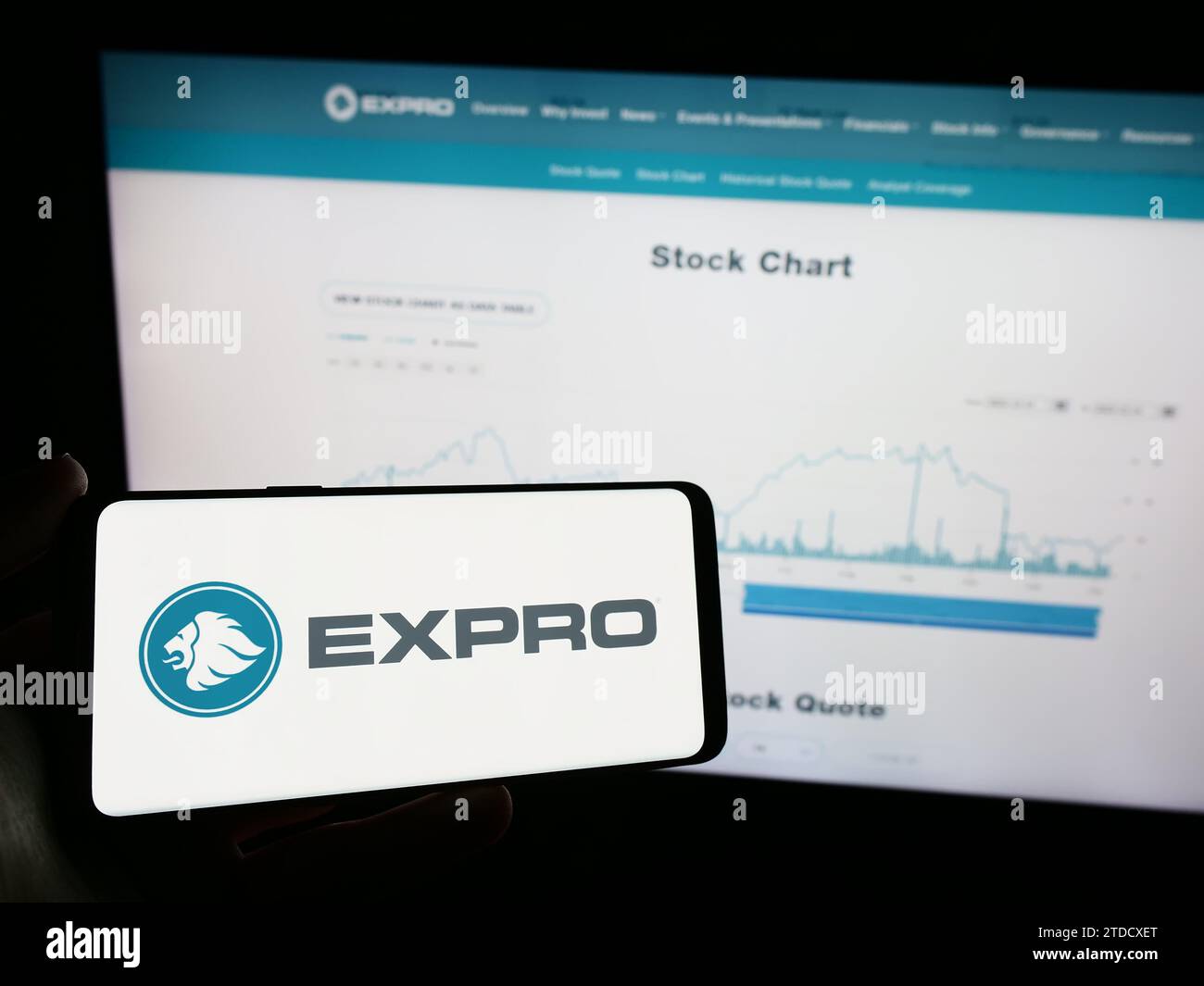 Person holding mobile phone with logo of American oil and gas company ...