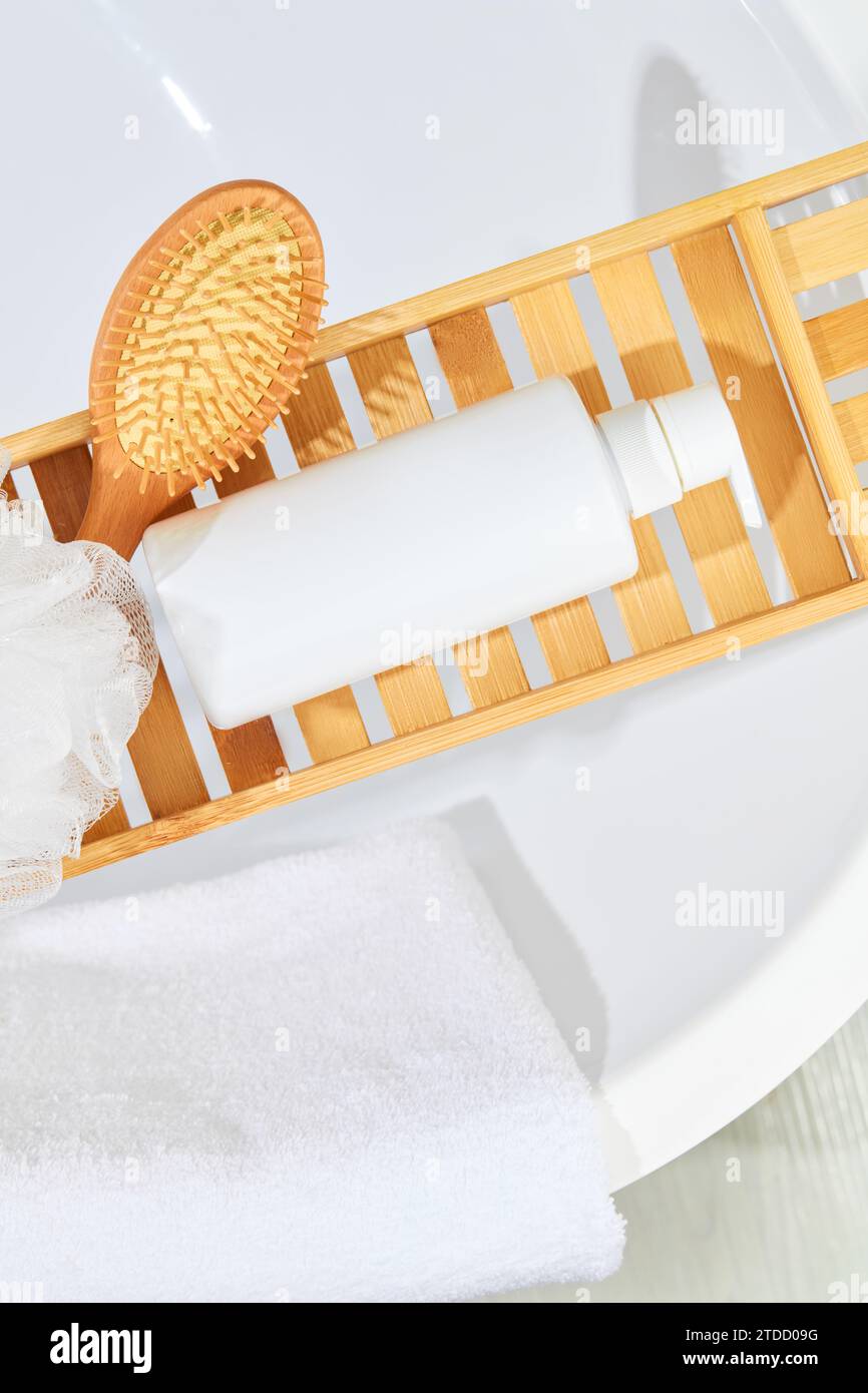 A detangling comb, an unlabeled bottle of shower gel and a shower ...