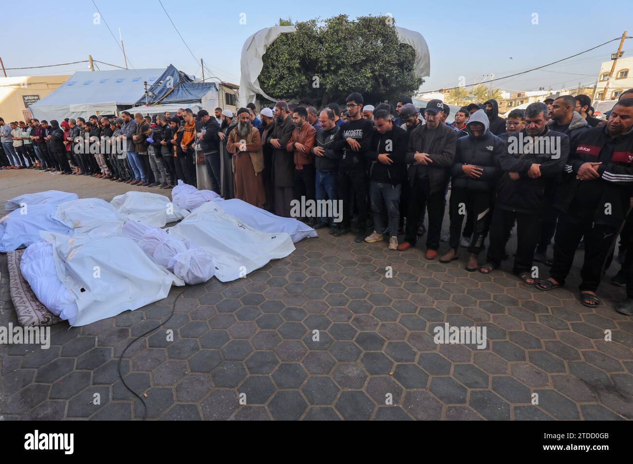 Palestinian people attend the funeral prayer for the Palestinians died ...