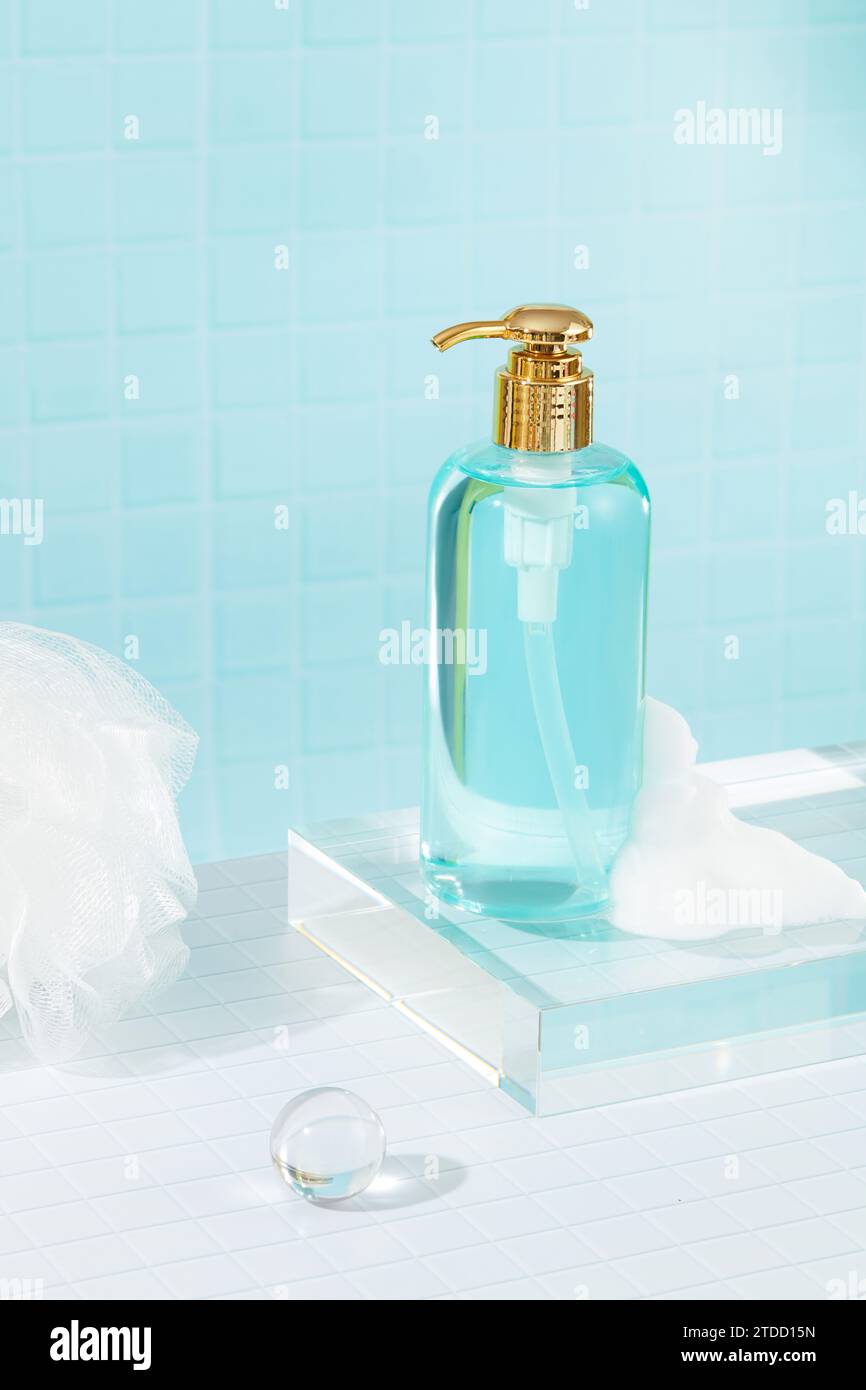 Close-up of a bottle of transparent shower gel and white foam on a ...