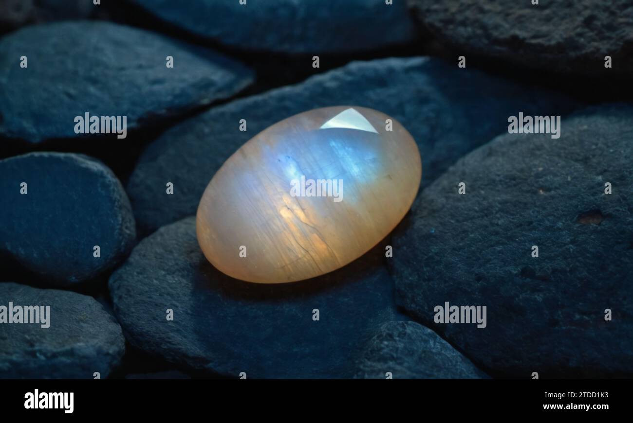 Natural precious moonstone on a dark gray background. Natural stone ...