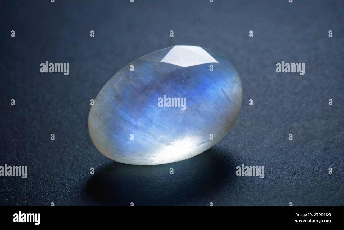 Natural precious moonstone on a dark gray background. Natural stone ...