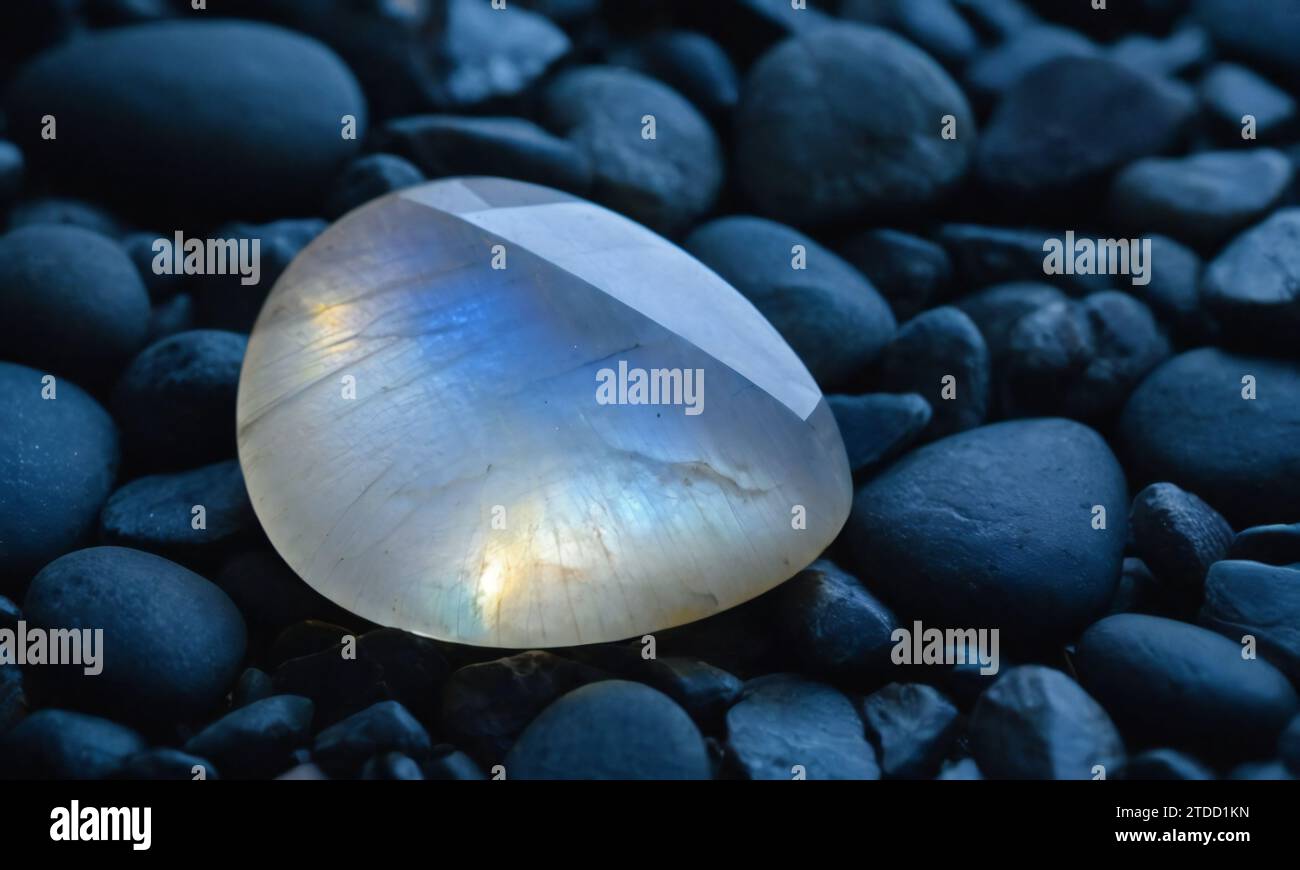 Natural precious moonstone on a dark gray background. Natural stone ...