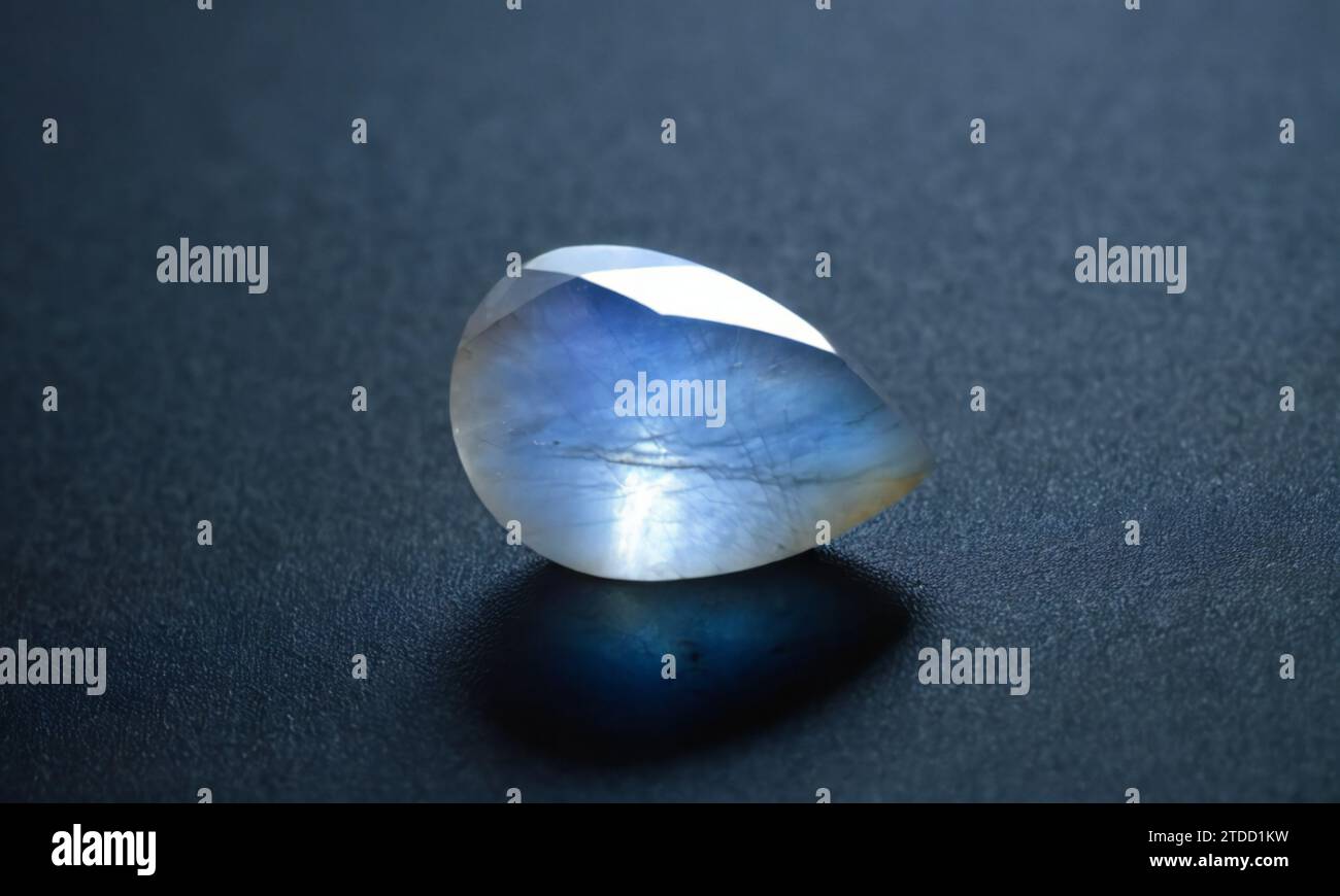 Natural precious moonstone on a dark gray background. Natural stone ...