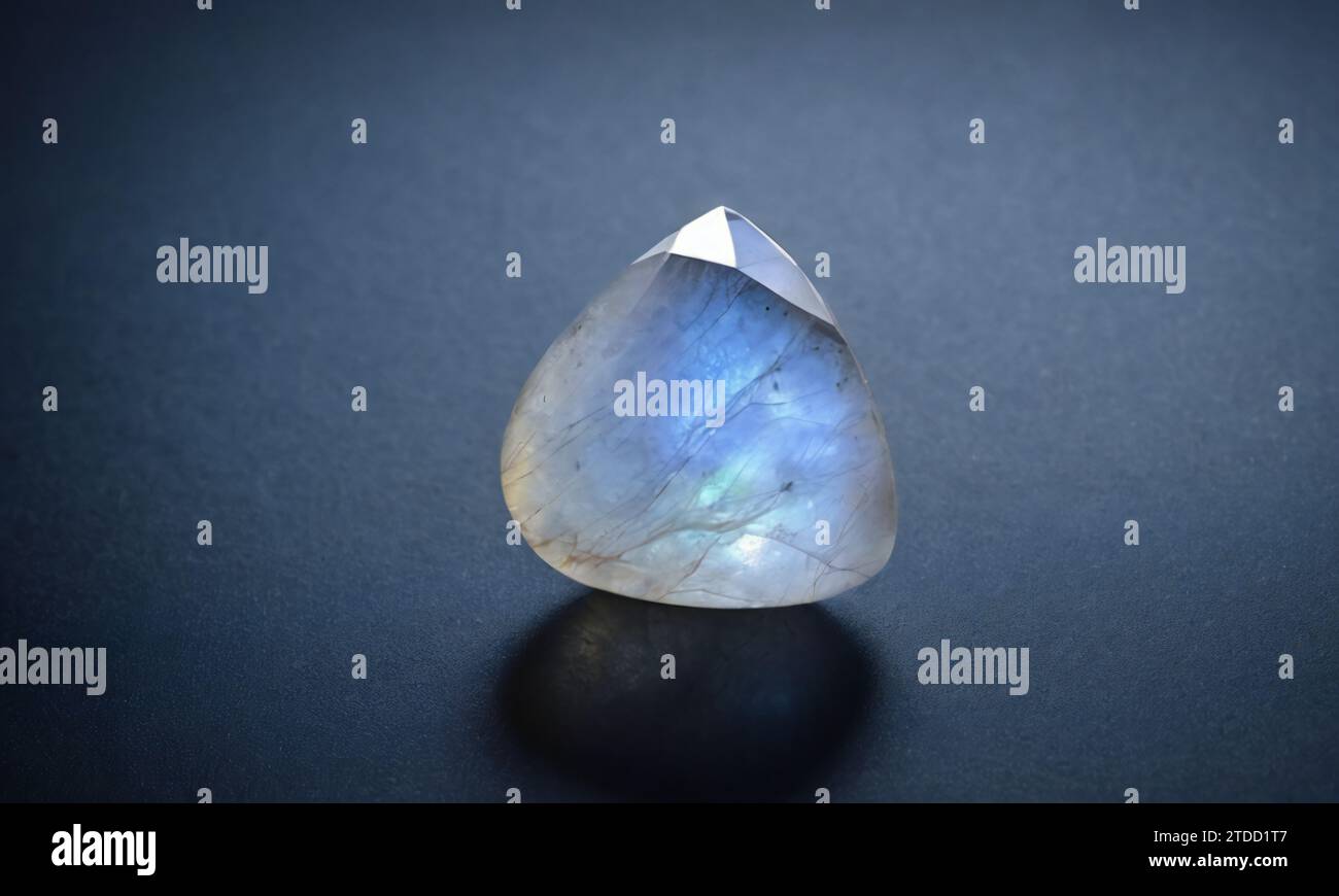 Natural precious moonstone on a dark gray background. Natural stone ...