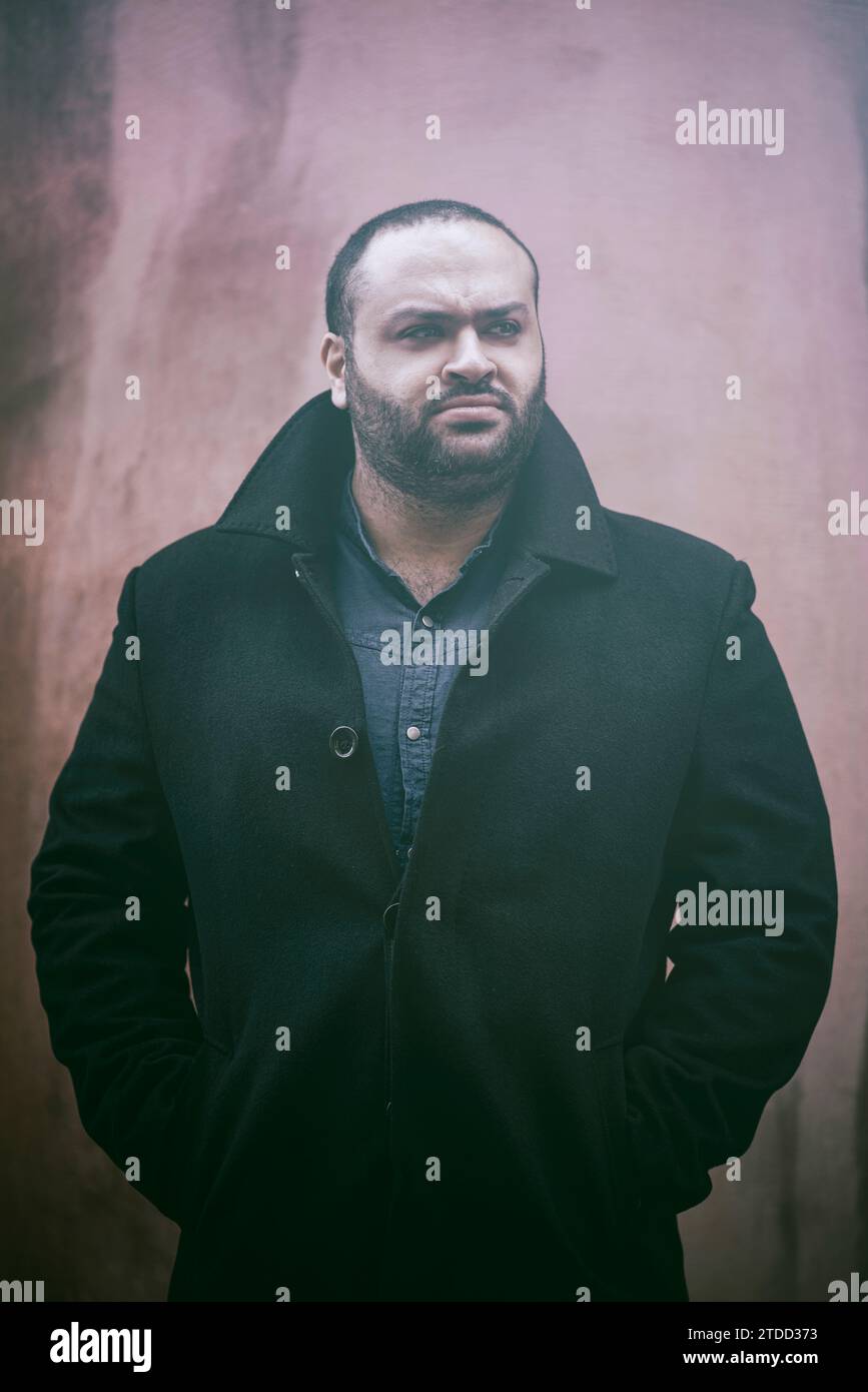 Bodyguard standing outdoors looking away Stock Photo - Alamy