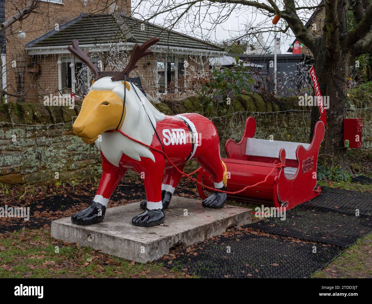 Santa's sleigh being pulled by a model lion decorated for Christmas ...