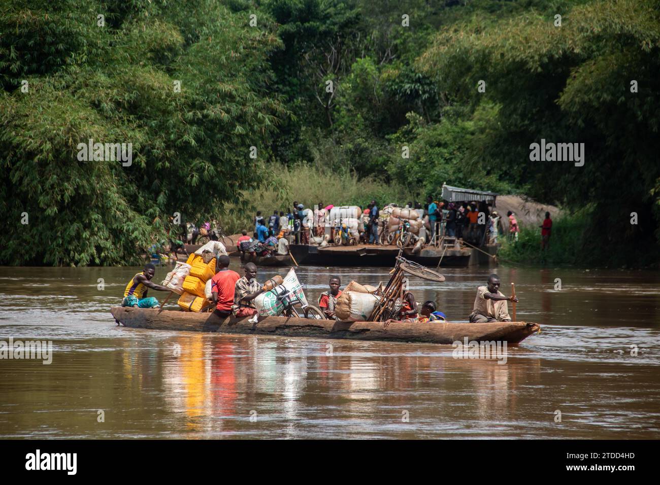 Transport of people across the Mbari river by locally made canoes and ...