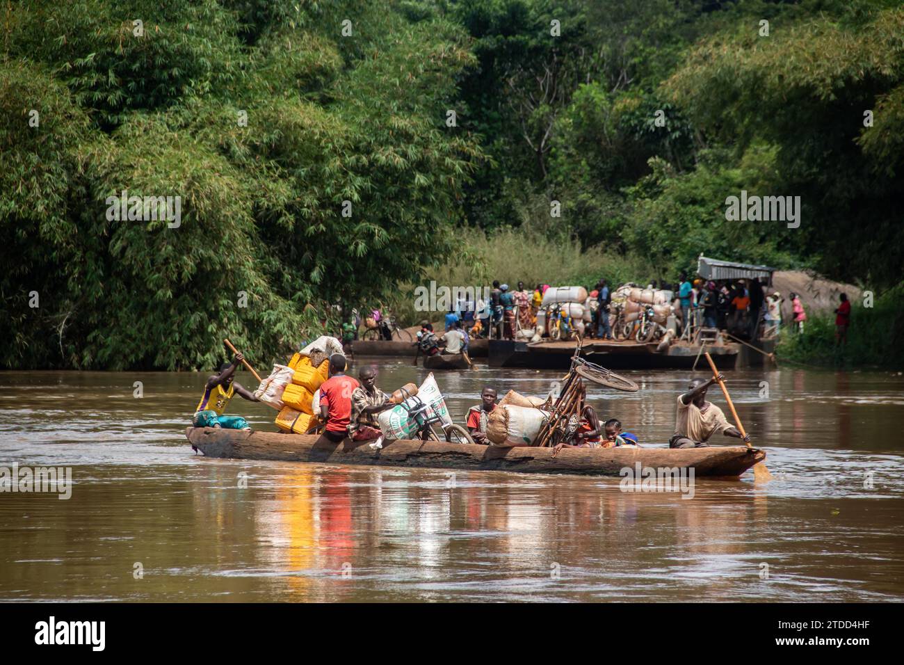 Transport of people across the Mbari river by locally made canoes and ...
