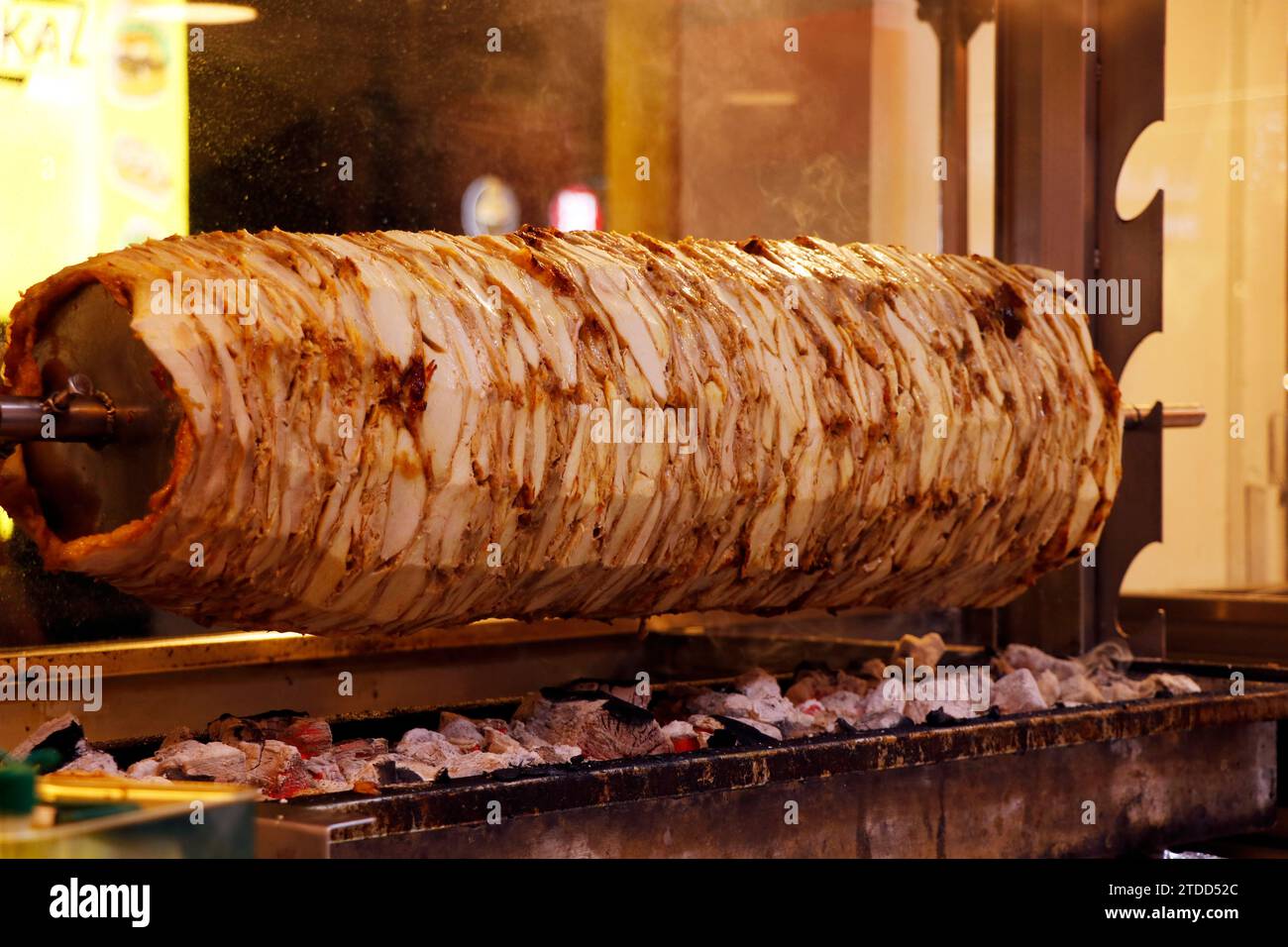 arabic middle eastern street food shawarma rolling on top of fire grill ...