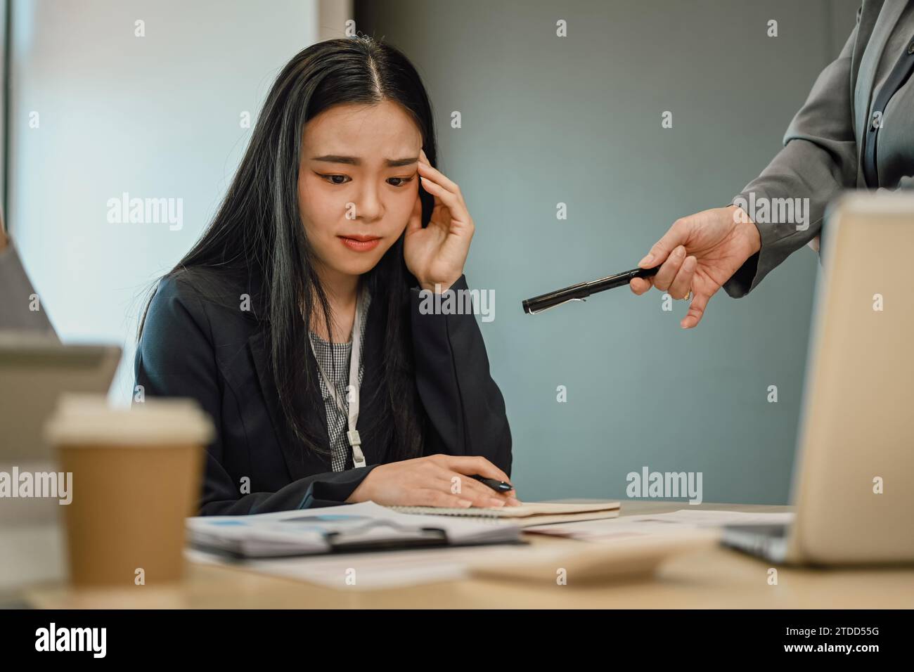 Upset asian female employee being scolded by supervisor complaining ...