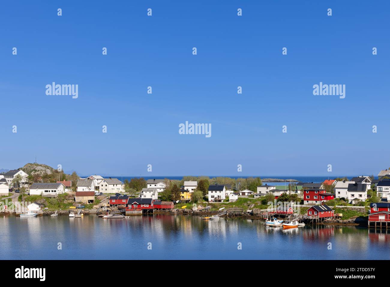 Reine, adorned with classic red Rorbu houses on a narrow isthmus in the ...