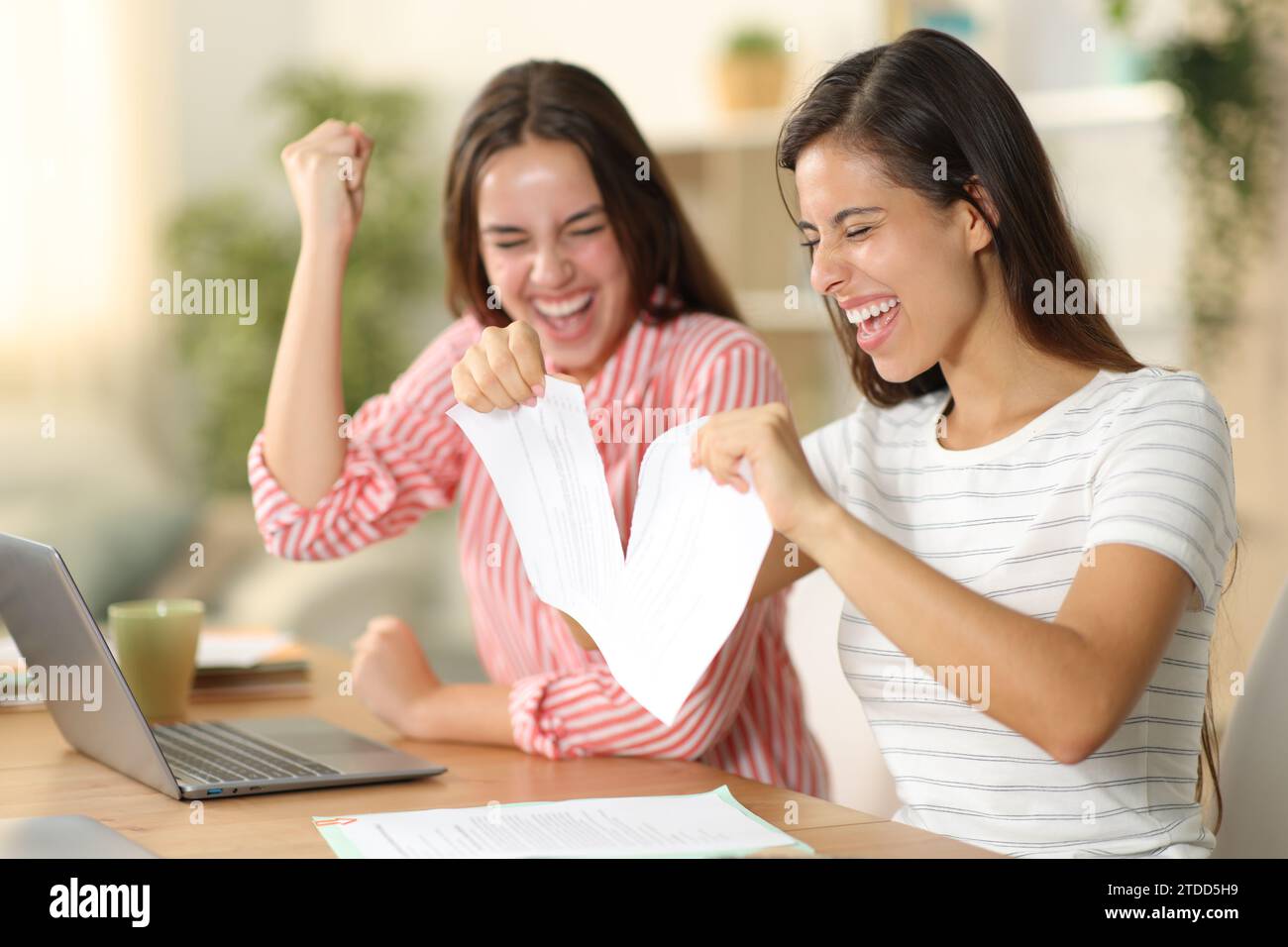 Two happy tele workers breaking contract celebrating at home Stock ...