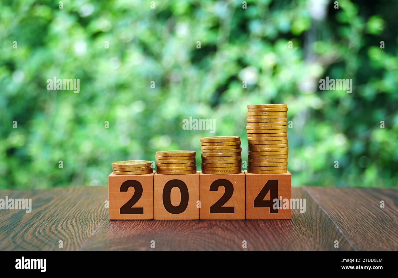 Stack coins on wooden block year 2024 using as business and financial ...