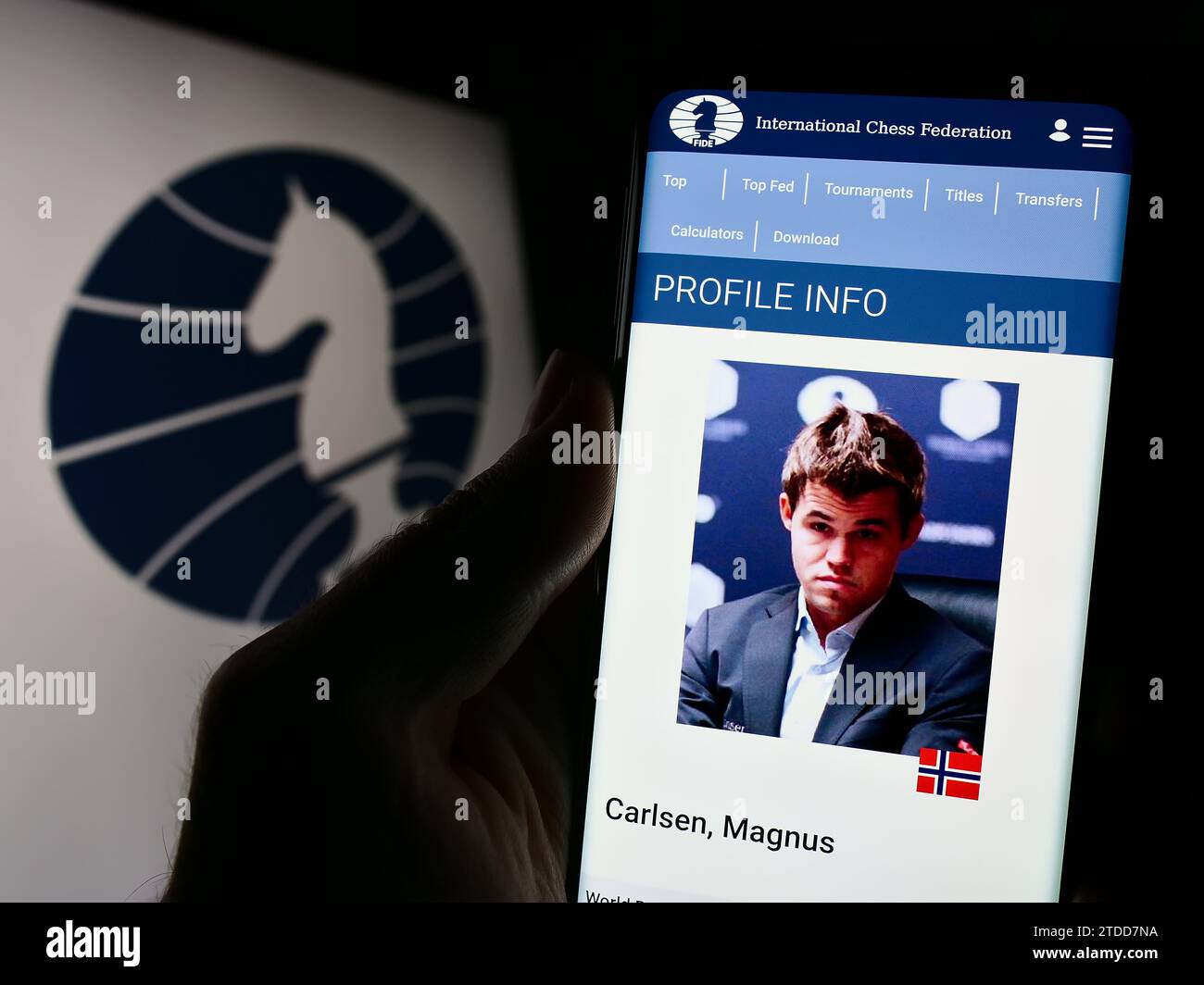 Person holding smartphone with webpage of organisation International ...