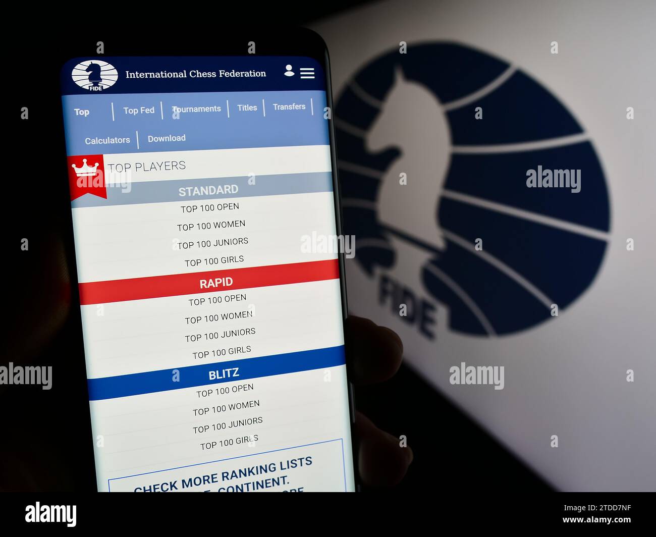 Person holding cellphone with web page of organisation International ...
