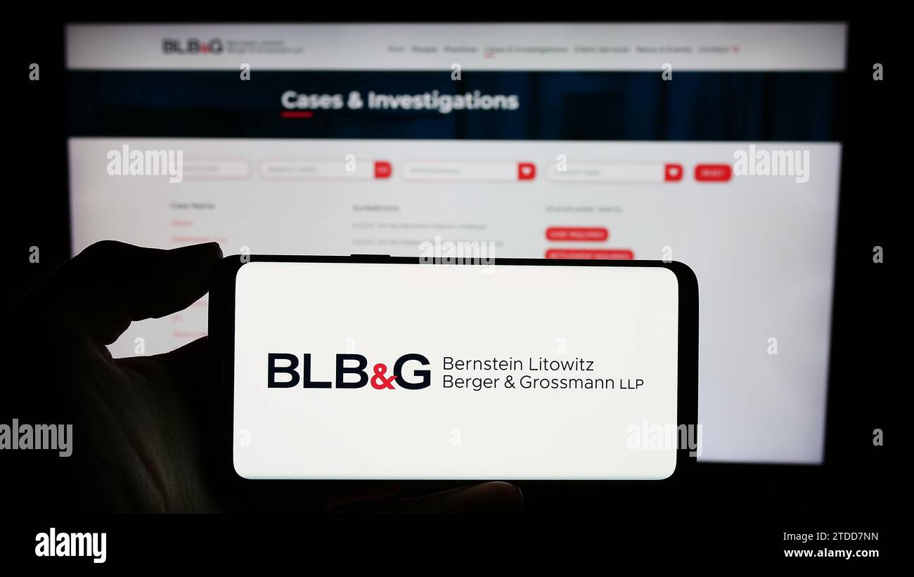 Person holding smartphone with logo of US law firm Bernstein Litowitz ...