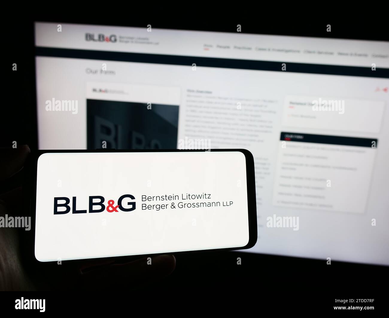 Person holding cellphone with logo of US law firm Bernstein Litowitz ...