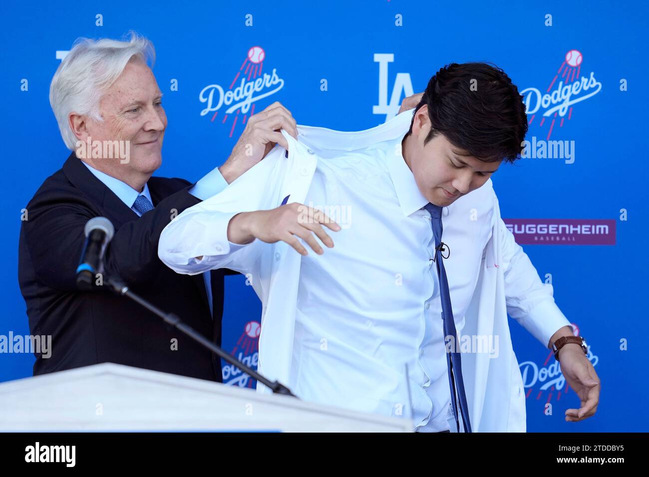 Los Angeles Dodgers owner & chairman Mark Walter, left, helps Shohei ...