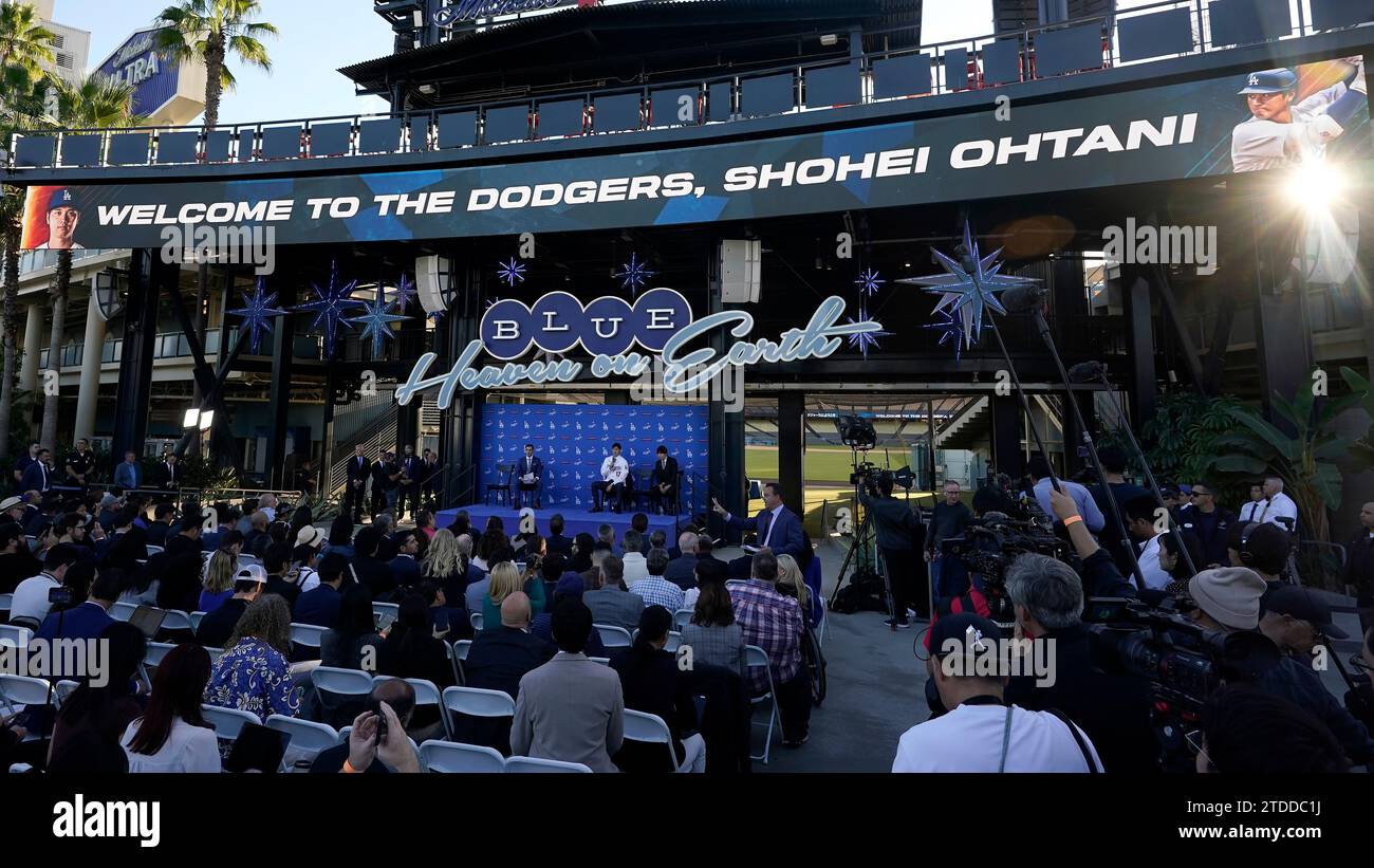 Los Angeles Dodgers' Shohei Ohtani, middle on stage, speaks during a ...