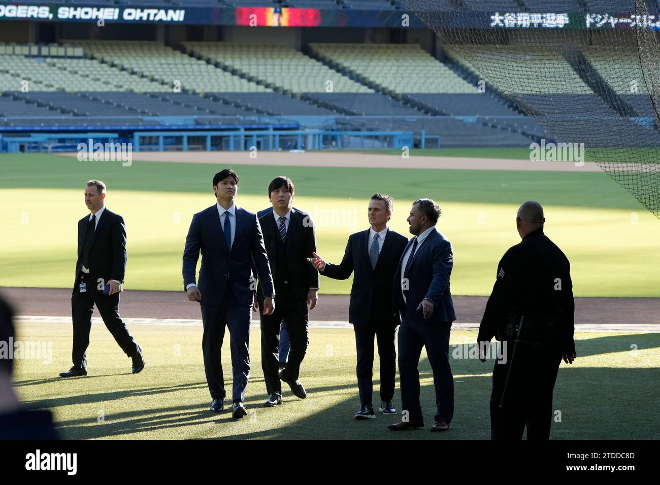 Los Angeles Dodgers' Shohei Ohtani, second from left, walks to a ...