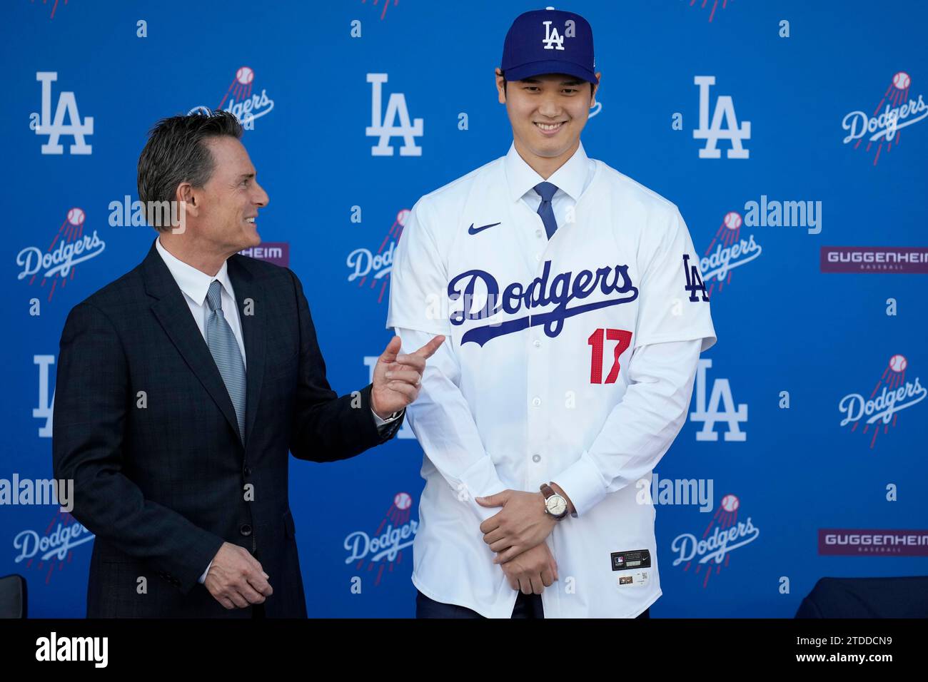 Los Angeles Dodgers' Shohei Ohtani, right, stands for photos next to ...