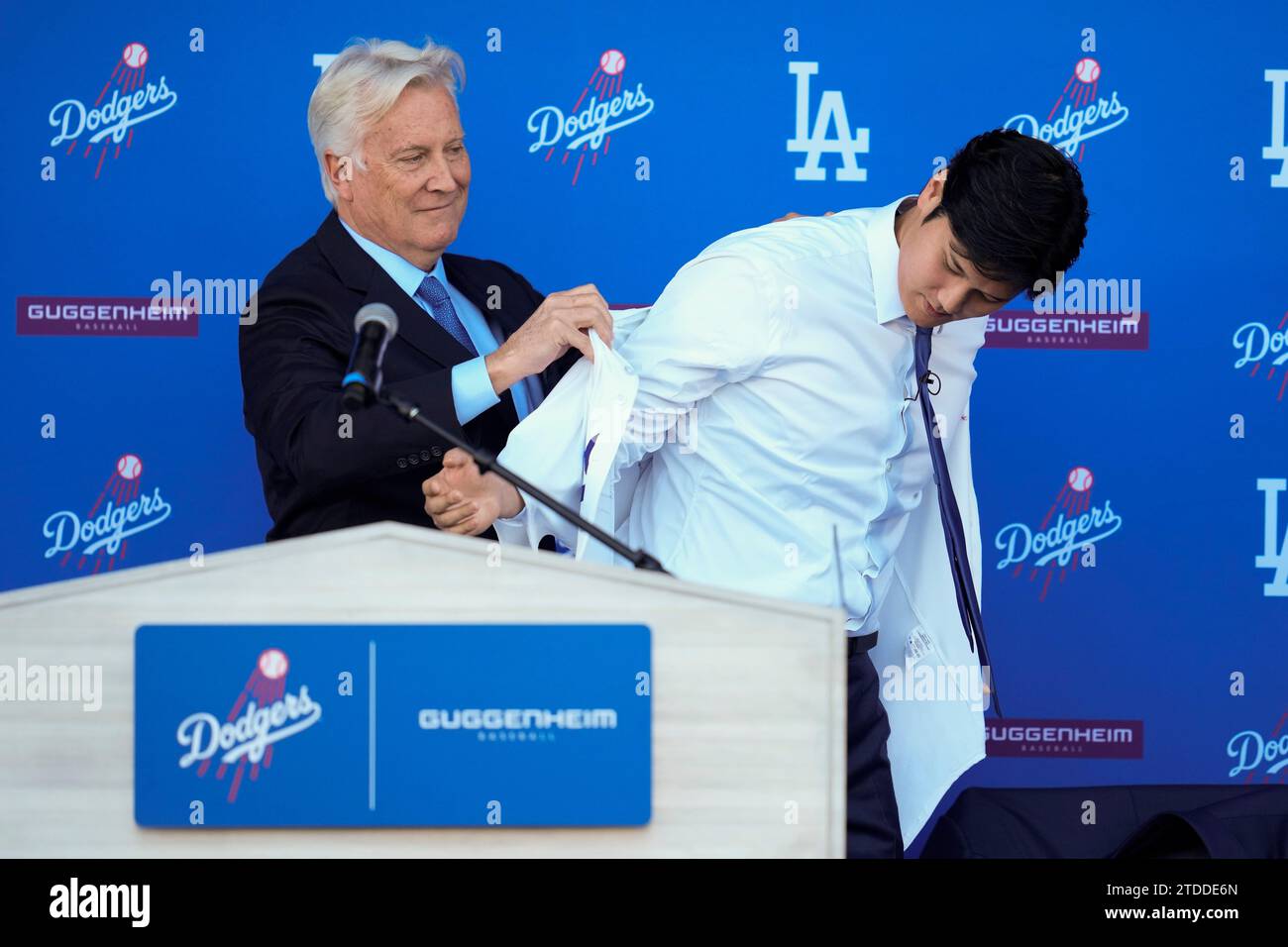 Los Angeles Dodgers owner and chairman Mark Walter, left, helps Shohei ...