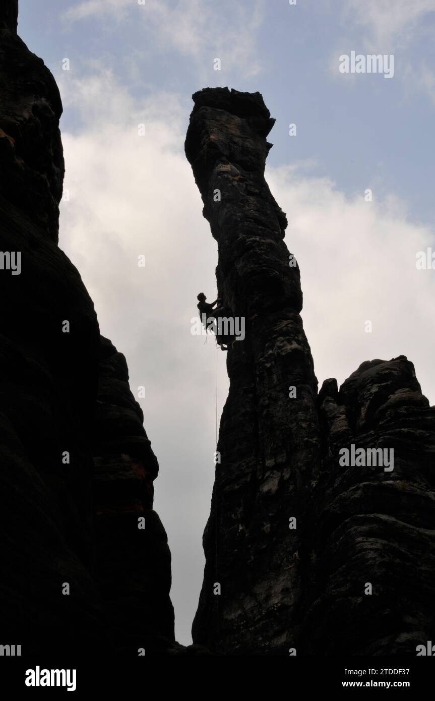 A climber ascends a rock spire Stock Photo - Alamy