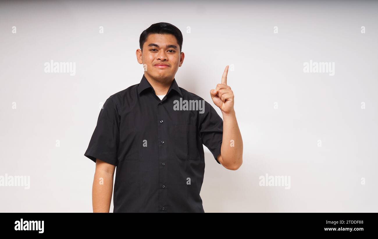 Smiling happy Young Asian man pointing both hands up on white ...