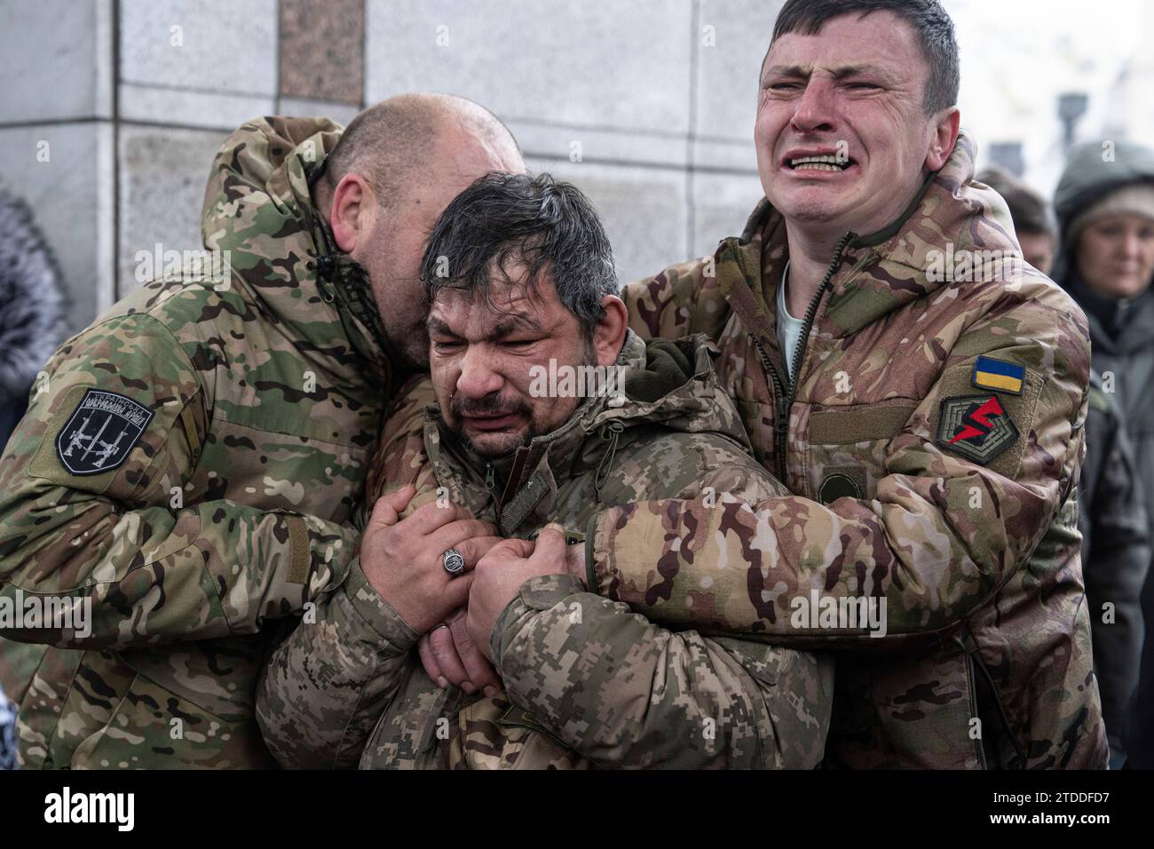 Ukrainian servicemen cry near the coffin of their comrade Andrii ...