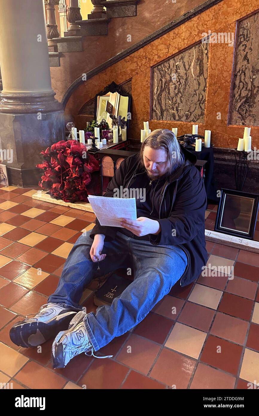 A man recites Christian prayers at a damaged Satanic display at the ...
