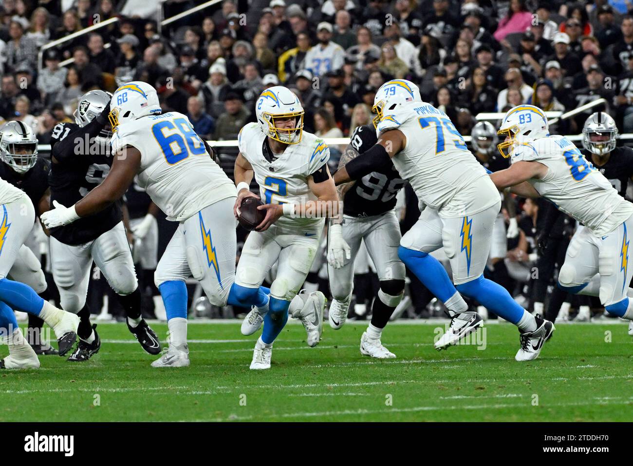 Los Angeles Chargers quarterback Easton Stick (2) looks to hand off the ...