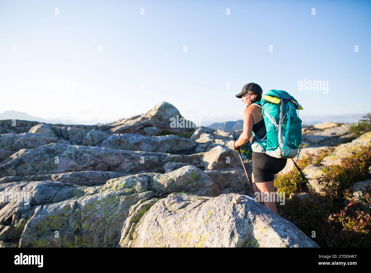 Side view of determined female hiker reaching mountain summit Stock ...