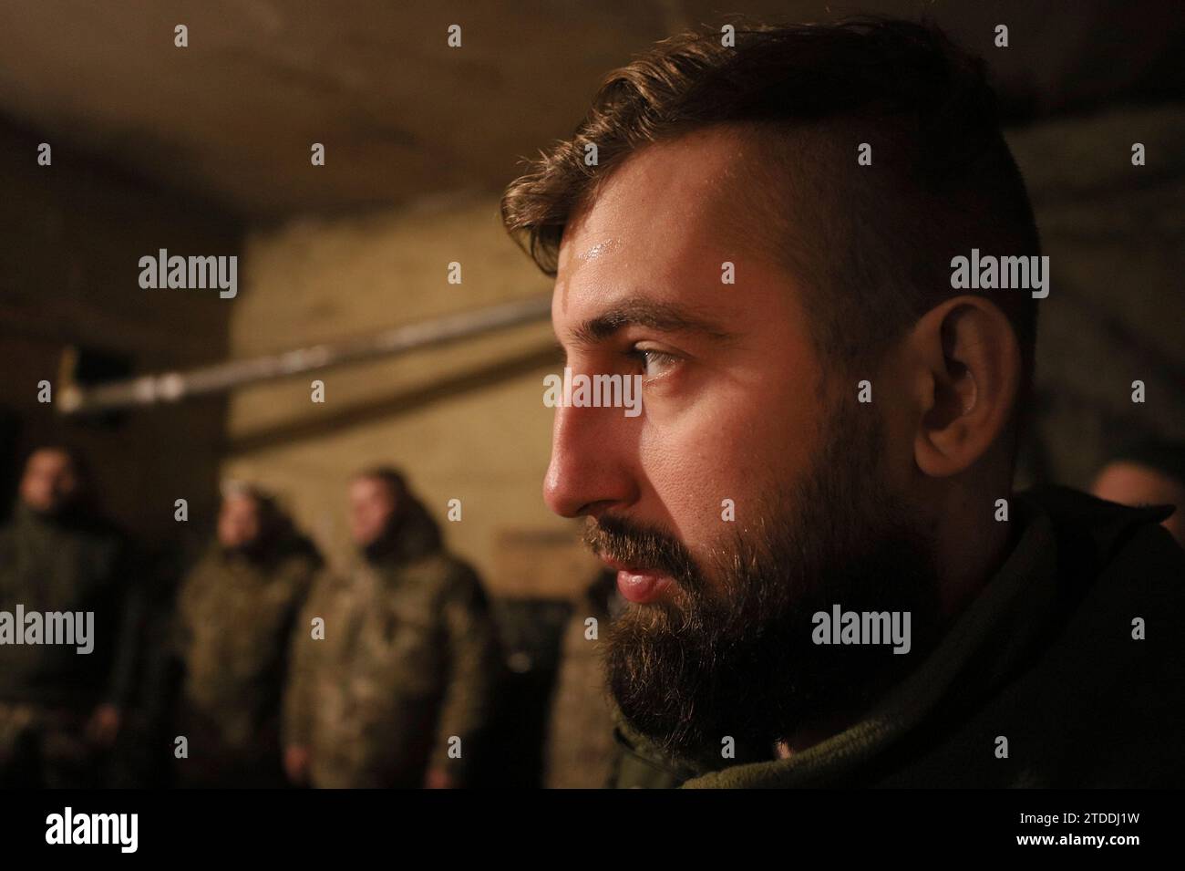 A Ukrainian serviceman of the 72nd mechanized brigade listens to a ...
