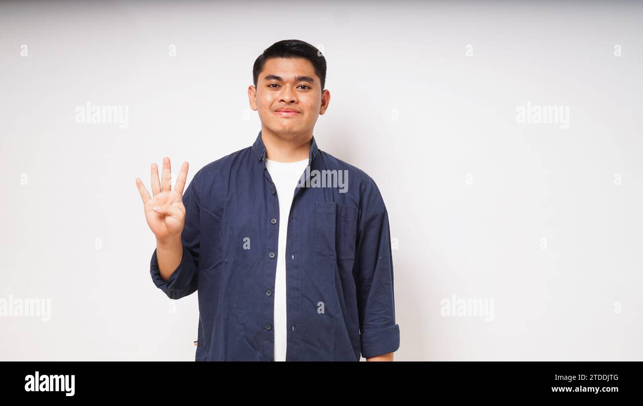 Young Asian man showing happy face expression while giving four fingers ...