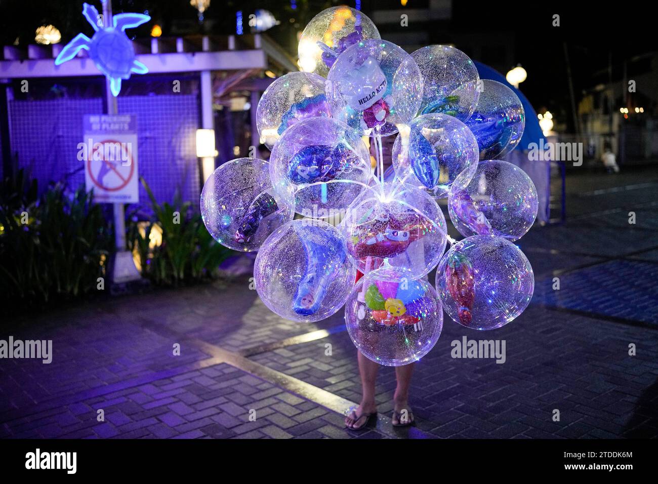 A Filipino sells balloons outside the International Shrine of Our Lady ...