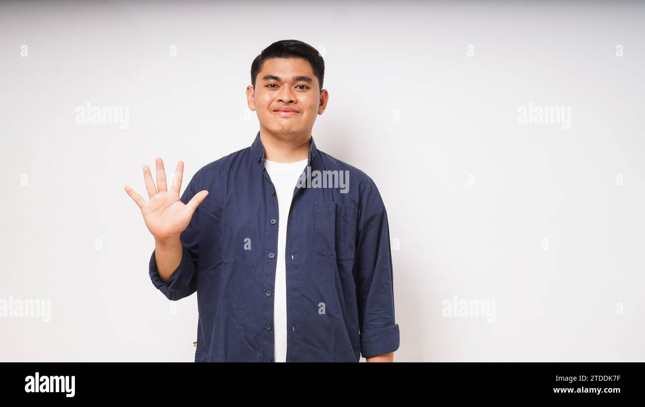 Young Asian man showing happy face expression while giving five fingers ...