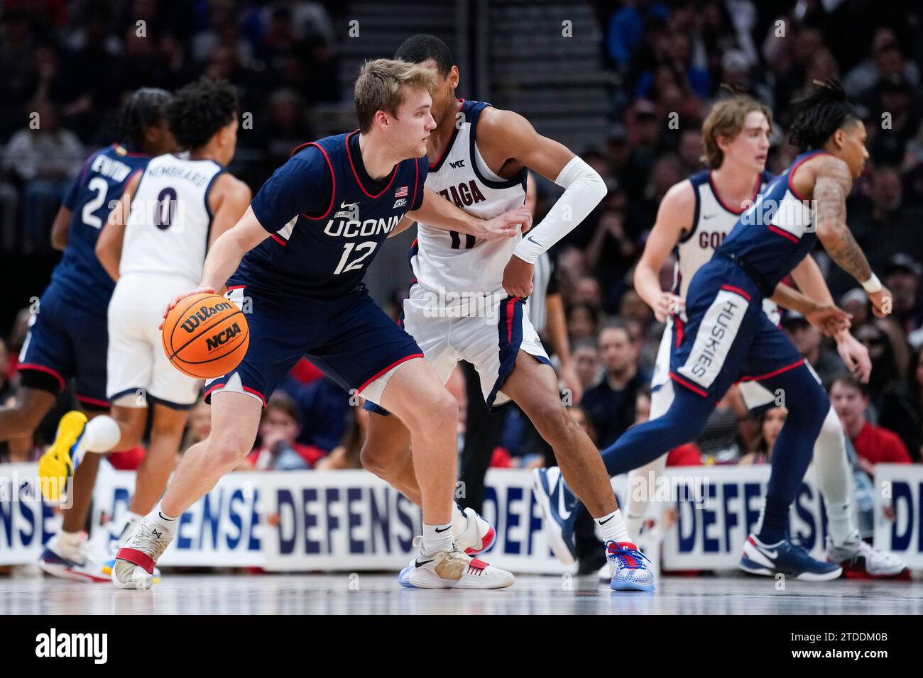 UConn guard Cam Spencer (12) is defended by Gonzaga guard Nolan Hickman ...