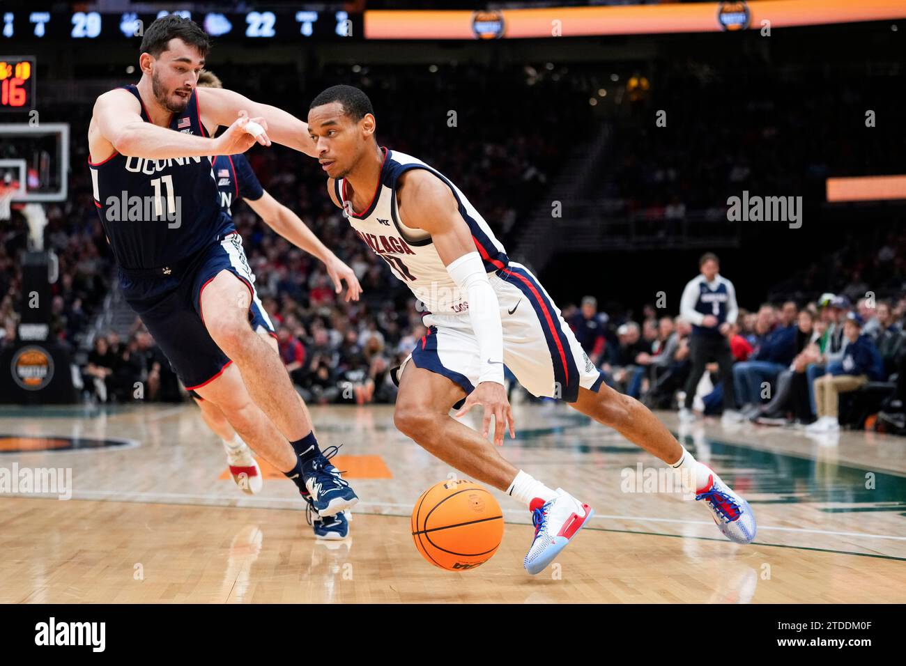 Gonzaga guard Nolan Hickman (11) drives to the basket against UConn ...