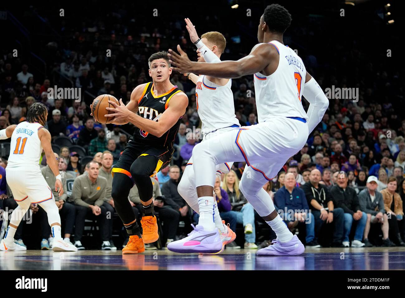 Phoenix Suns guard Grayson Allen drives as New York Knicks guard Donte DiVincenzo, center ...