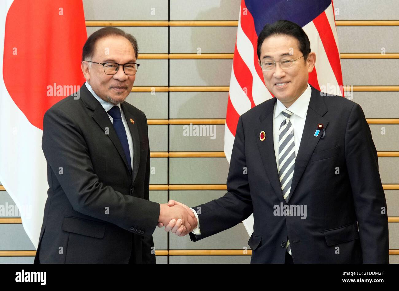 Japanese Prime Minister Fumio Kishida, right, shakes hands with ...