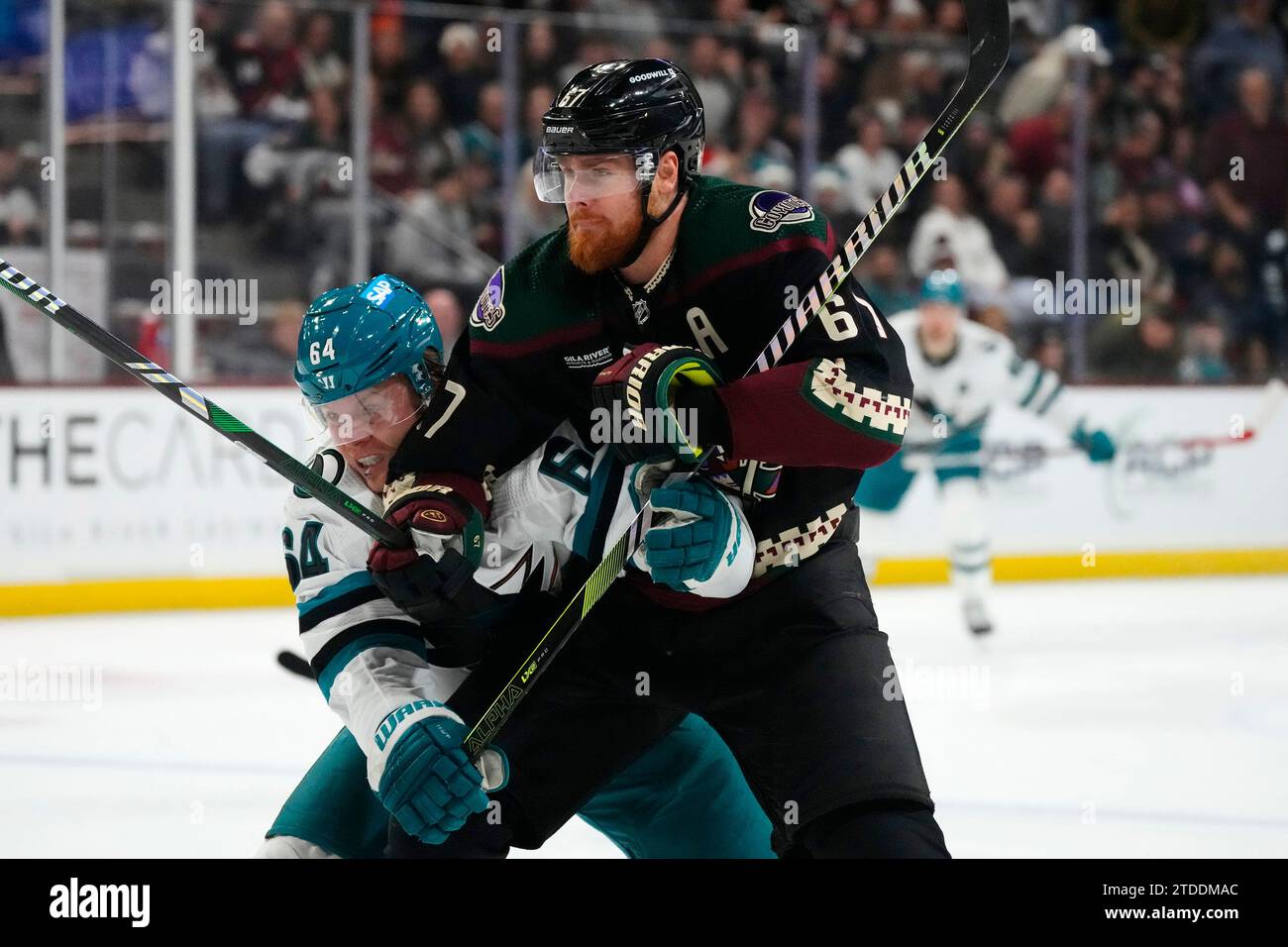 Arizona Coyotes left wing Lawson Crouse (67) checks San Jose Sharks ...