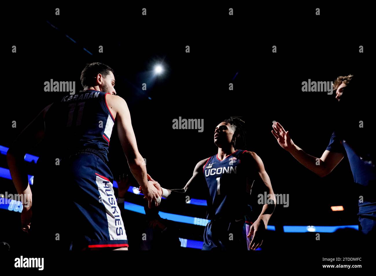 UConn forward Alex Karaban (11) greets guard Solomon Ball (1) and guard ...