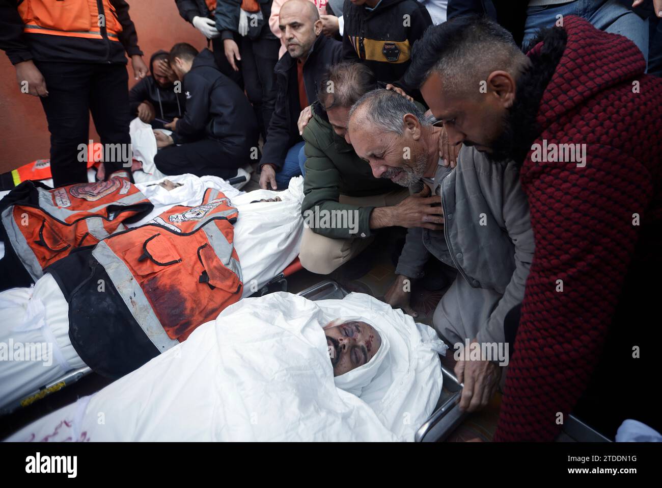 Palestinians mourn over the bodies of Al Jazeera cameraman, Samer Abu Daqqa, and three civil ...