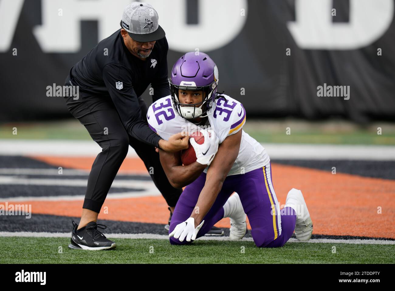 Minnesota Vikings running back Ty Chandler (32) gets help from a coach ...